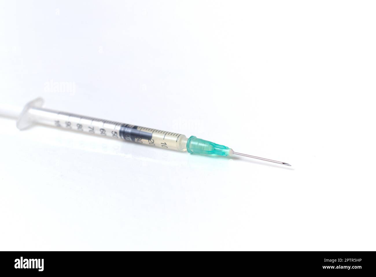 Plastic disposable syringe on white background Stock Photo - Alamy