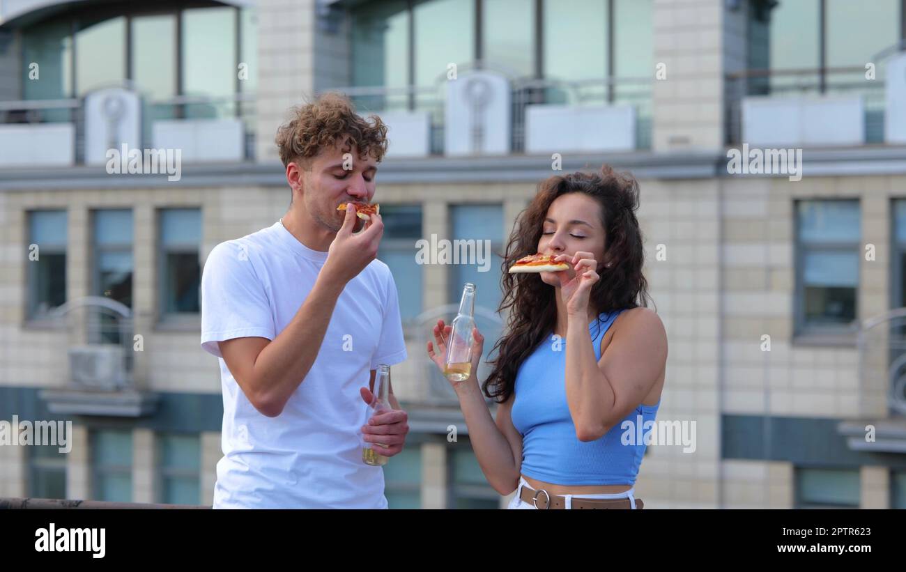 Portrait of young cheerful couple male and female dancing while ...