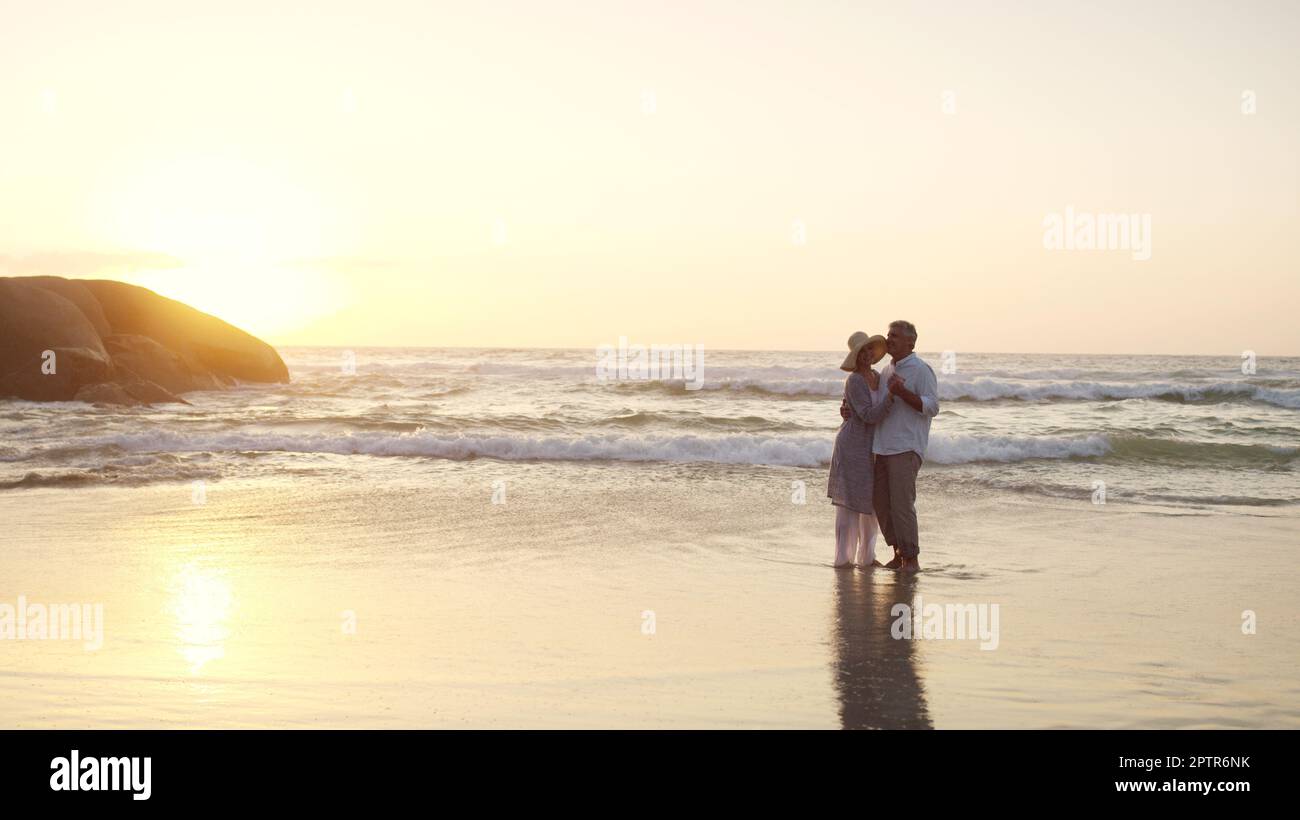 Dancing while the ocean waves. Full length shot of an affectionate ...