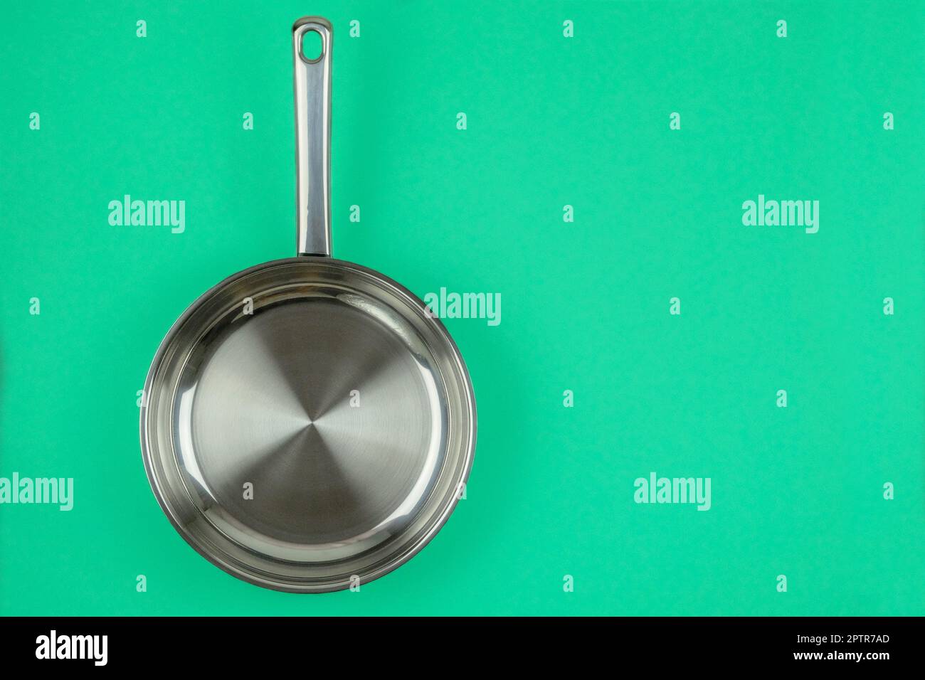 Frying pan on a green background. Cooking concept. Top view Stock Photo ...