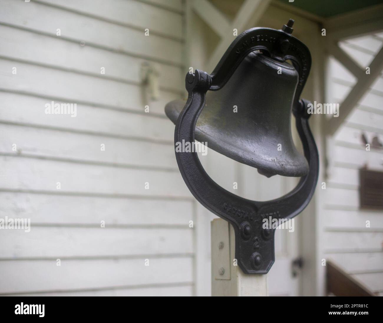 A school bell in front of an old school house Stock Photo - Alamy