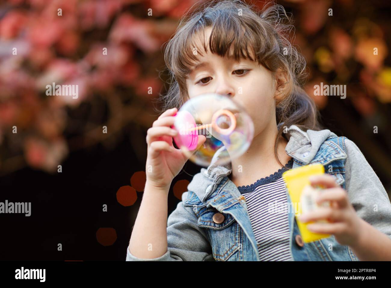 Having bubble fun. a little girl blowing bubbles outdoors Stock Photo ...