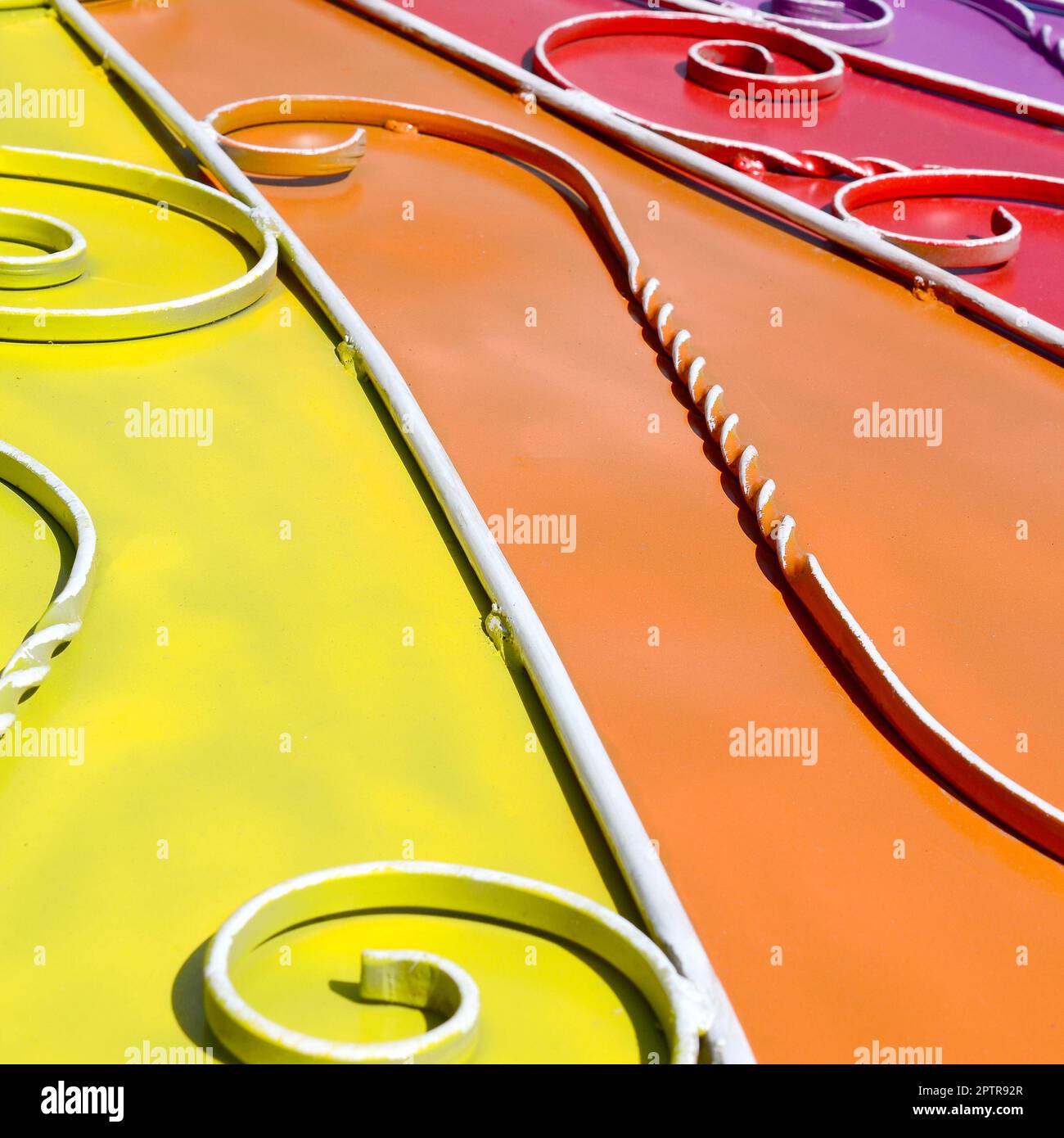 Metal texture of a piece of colored wall with a forged pattern. Rainbow ...