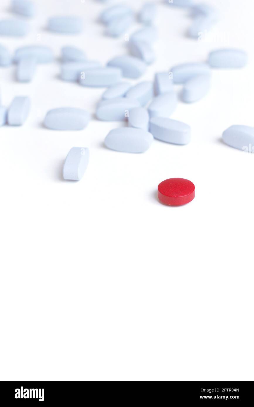 Medication, placebo concept . Single red pill shown prominently among ...