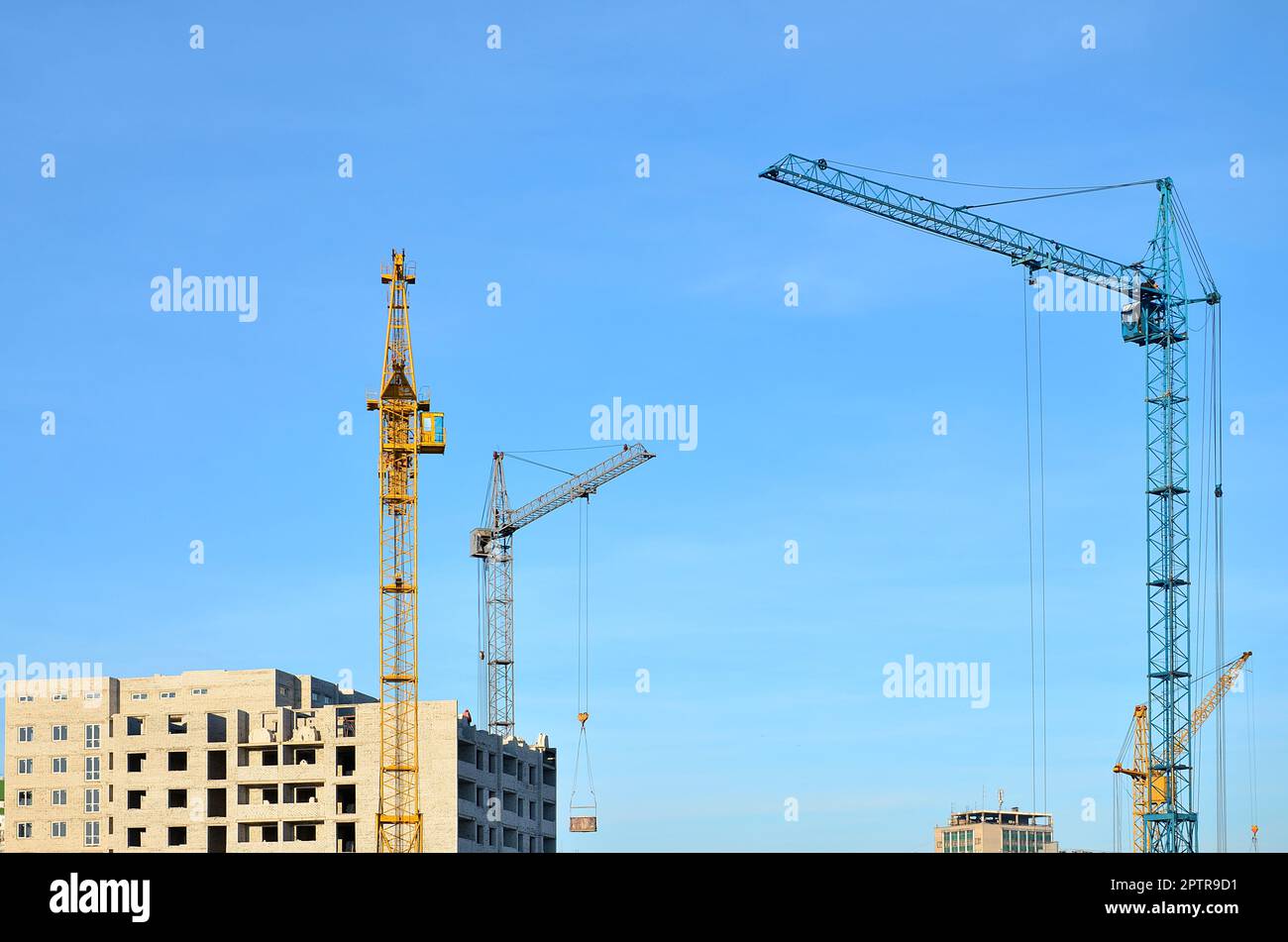 Working tall cranes inside place for with tall buildings under ...
