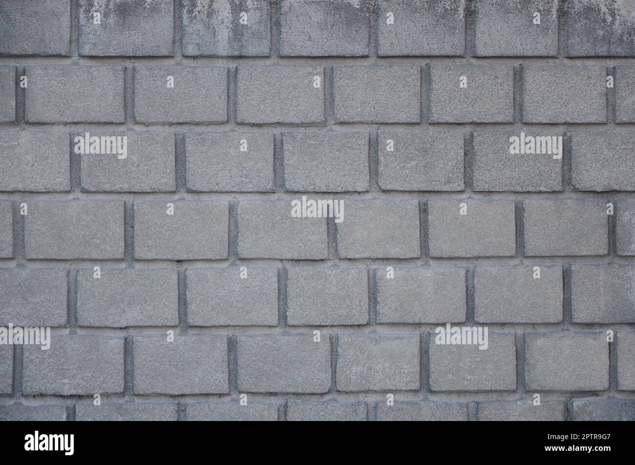 Weathered stained old block wall background. Texture of an old wall of ...