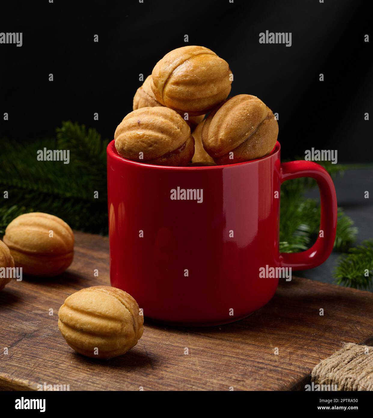 Baked nut-shaped dessert in a red ceramic mug Stock Photo - Alamy