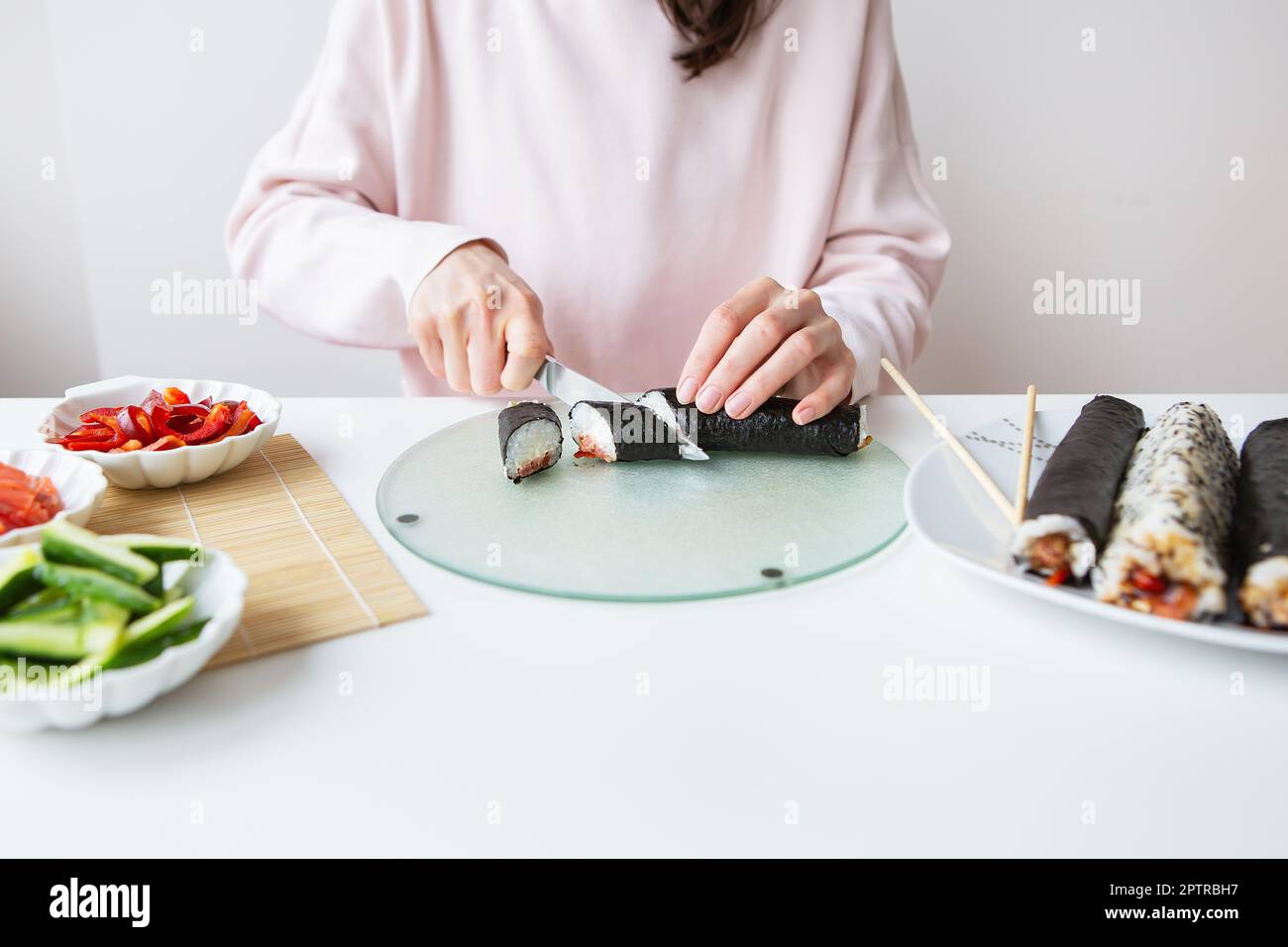 The process of making sushi, the girl makes sushi with different ...