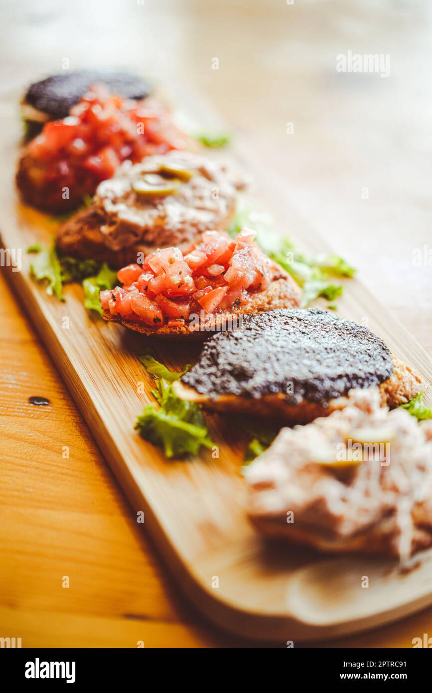 Selection of Spanish tapas served on a sliced baguette Stock Photo - Alamy