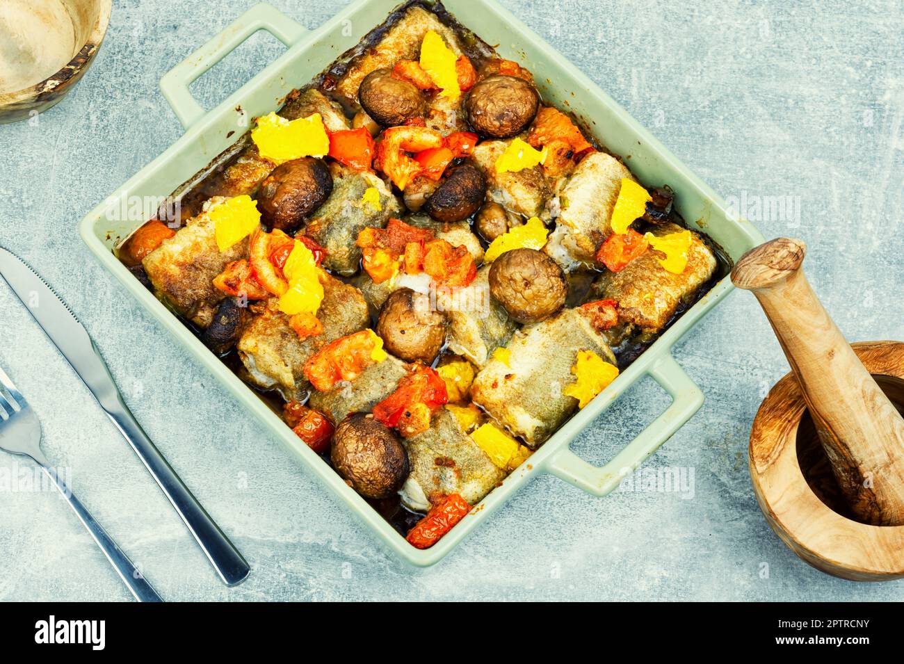 Baked hake fish with orange, tomato and mushrooms Stock Photo - Alamy