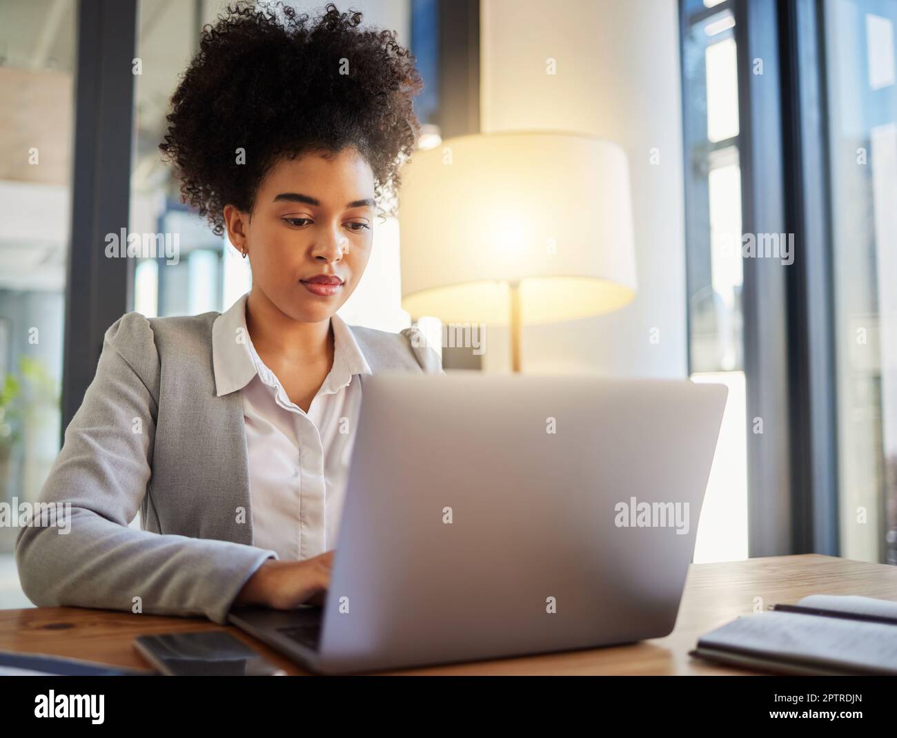 Laptop, typing and serious business woman reading emails at desk ...