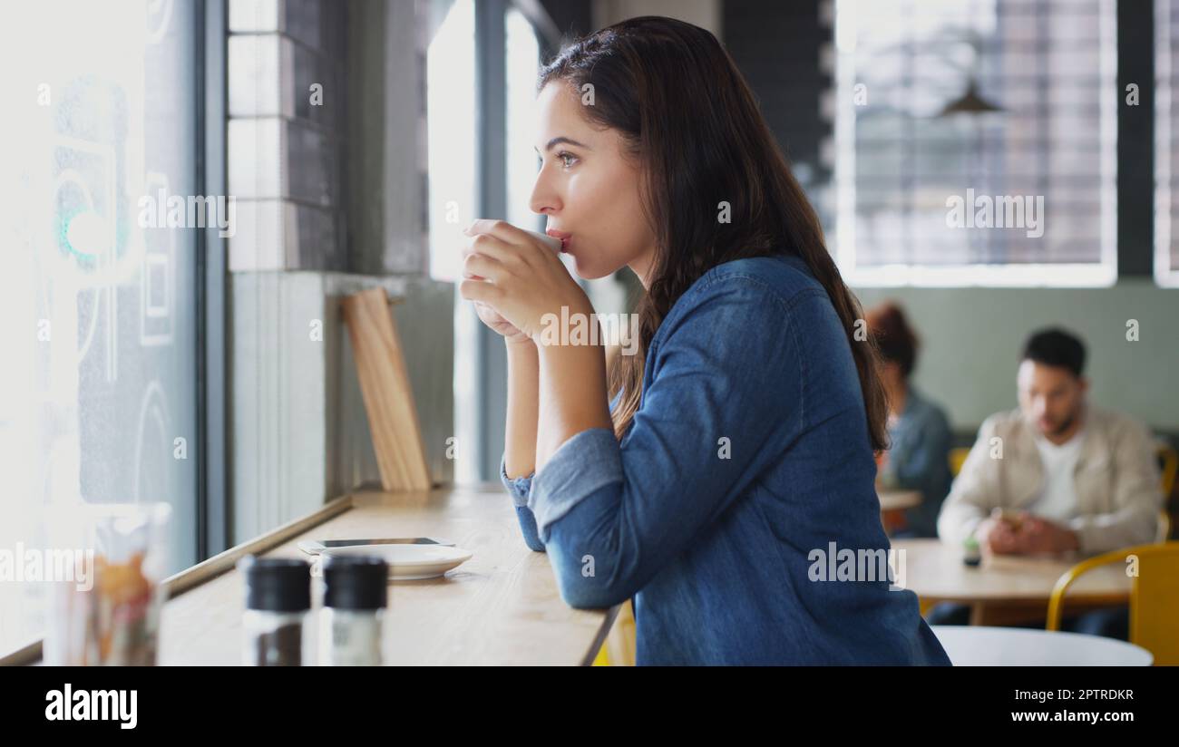 Beautiful woman stirs coffee sitting hi-res stock photography and ...