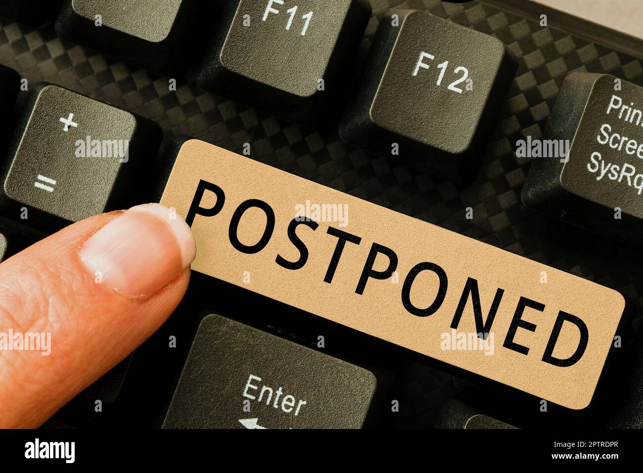 Sign displaying Postponed, Word for to place later in order of ...