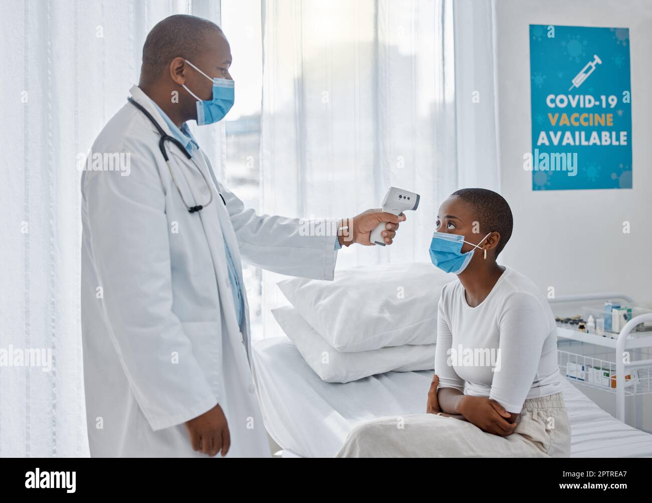 Doctor checking temperature of covid patient while testing for high ...