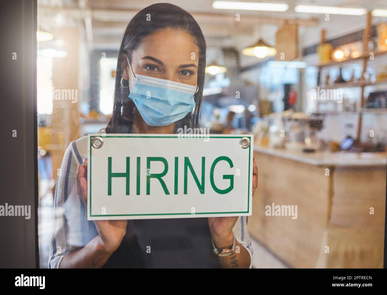 Business woman advertising a hiring sign in her startup coffee shop ...
