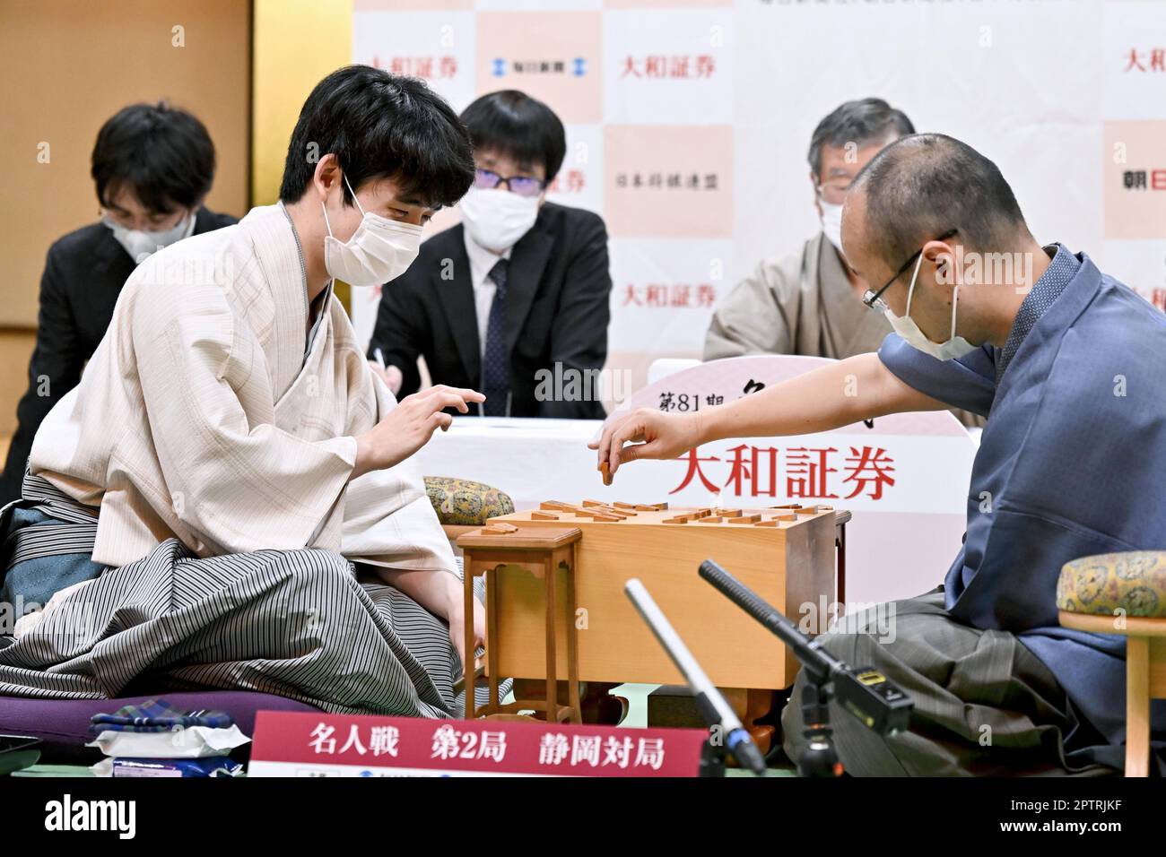 Shogi prodigy Sota Fujii (L) reviews his match against defending ...