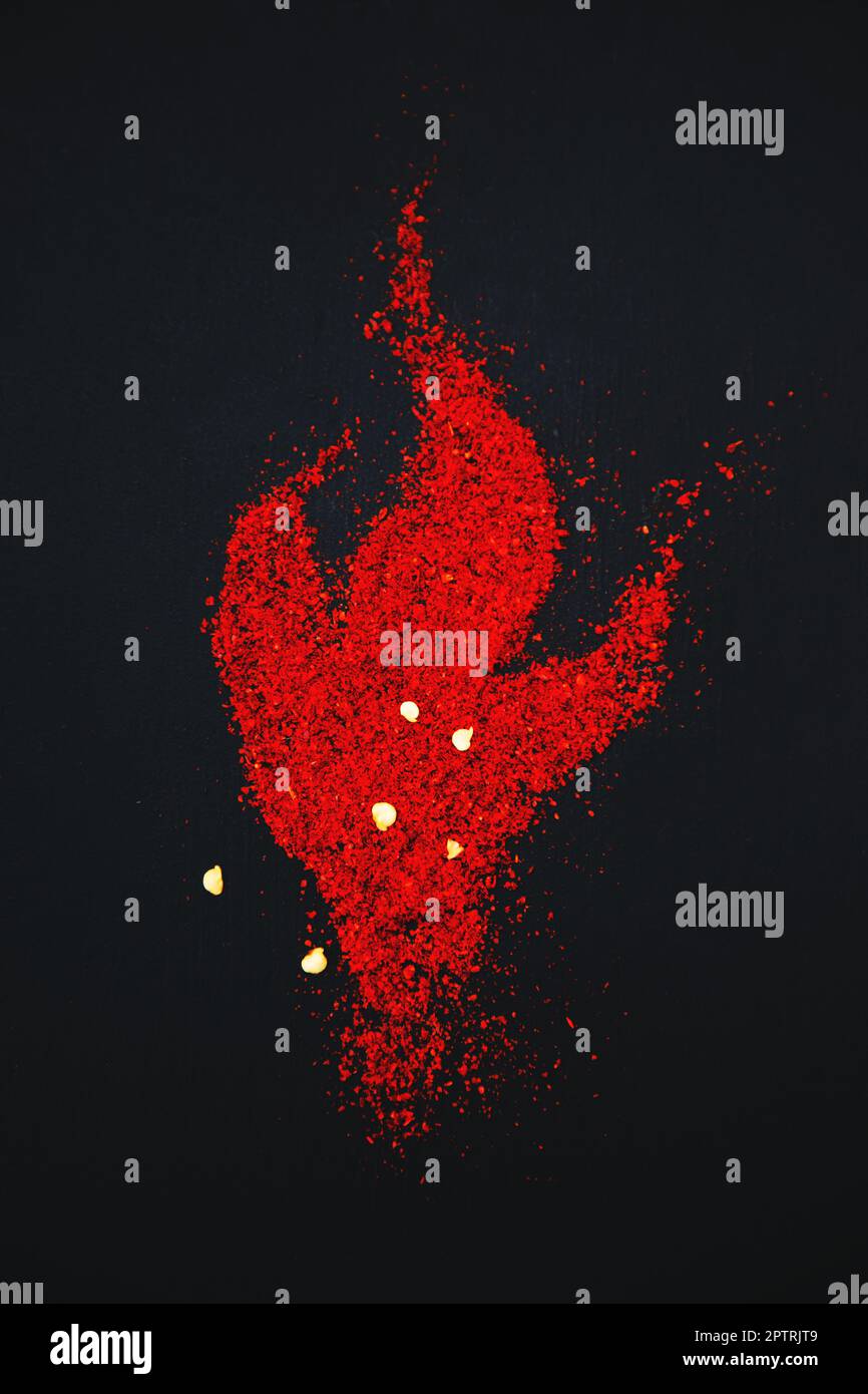 Dry chili pepper in the form of a flame. Dark background Stock Photo ...