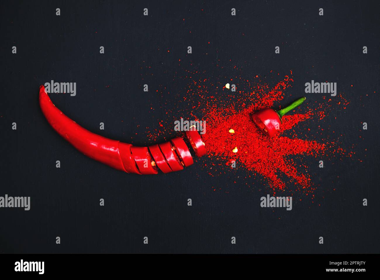 Exploding pepper. Chili pepper turns into powder. Dark background Stock ...