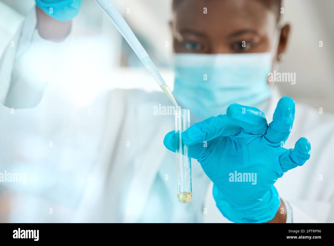 Waiting for the colour to change. a young scientist sitting alone in ...