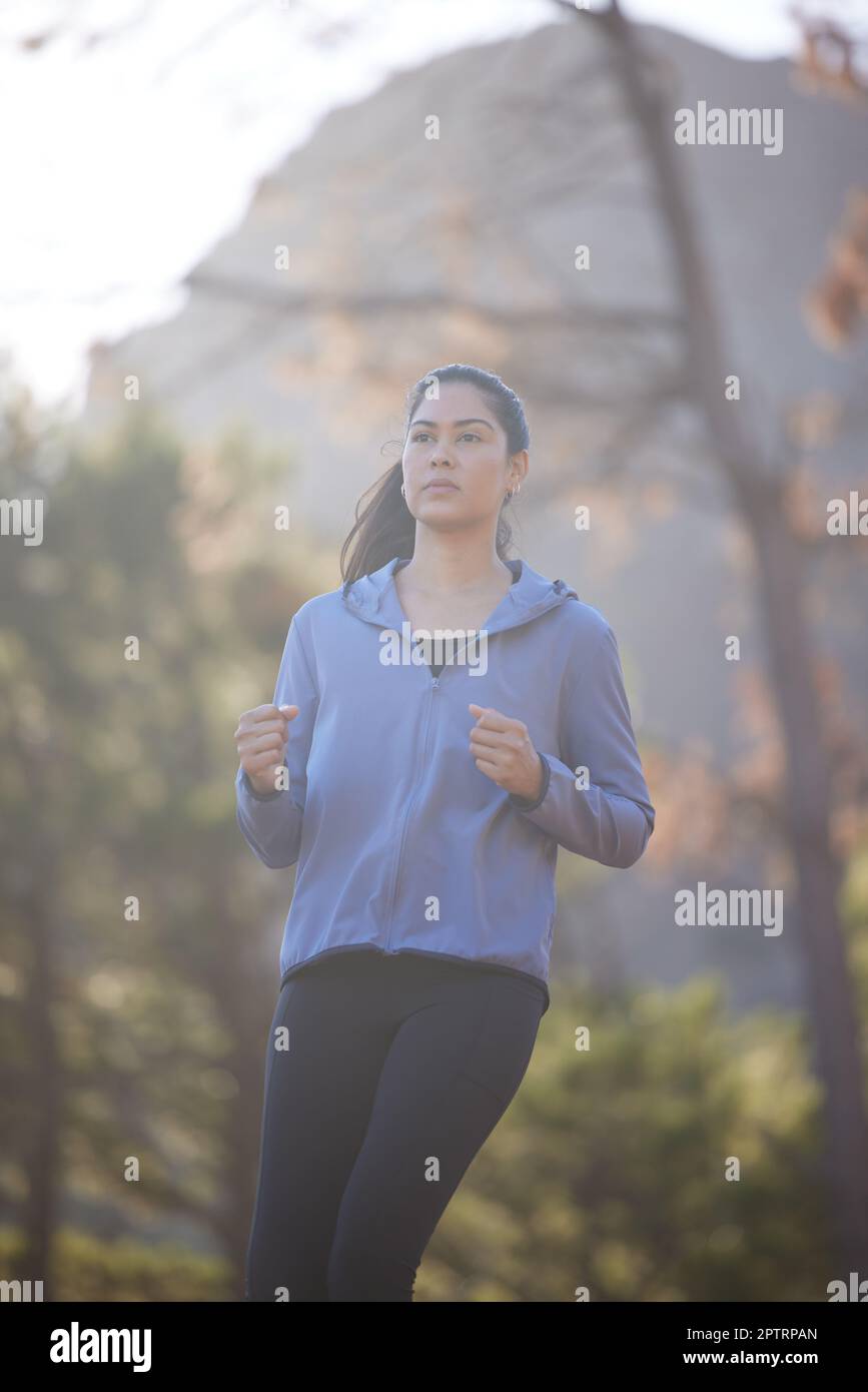 Woman, running and runner on nature run in forest for healthy fitness ...