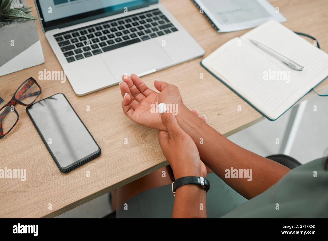 Wrist, arm and pain by laptop desk of employee worker suffering from ...