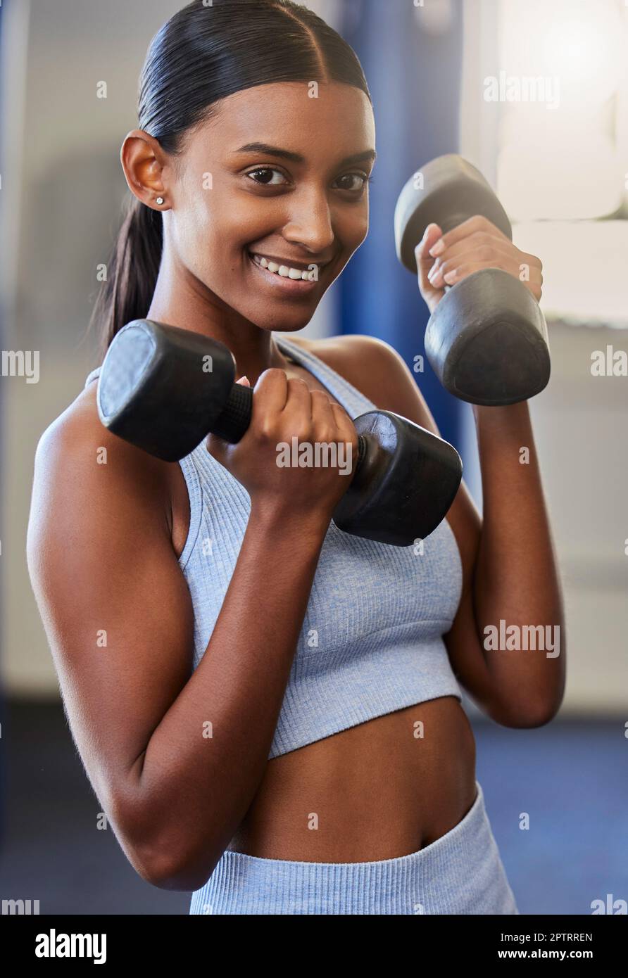 Fitness, Indian woman and dumbbell training portrait in gym for workout ...
