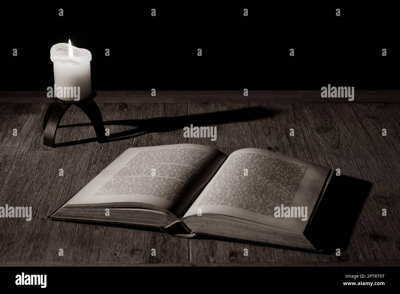 The old Book with a Candle Stock Photo - Alamy