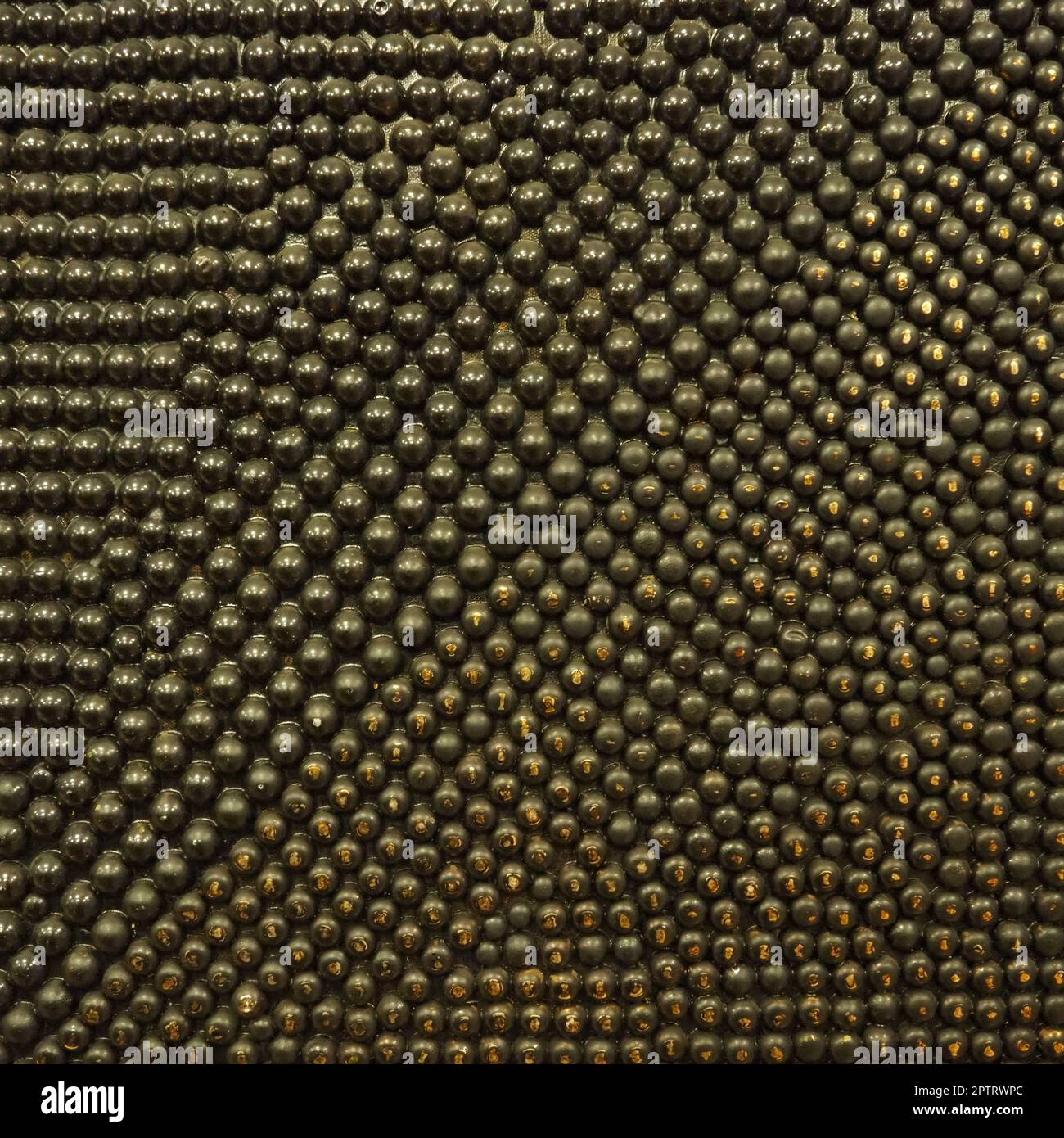 Pimples or spikes made of black and gold metal. Metal rounded bulges ...