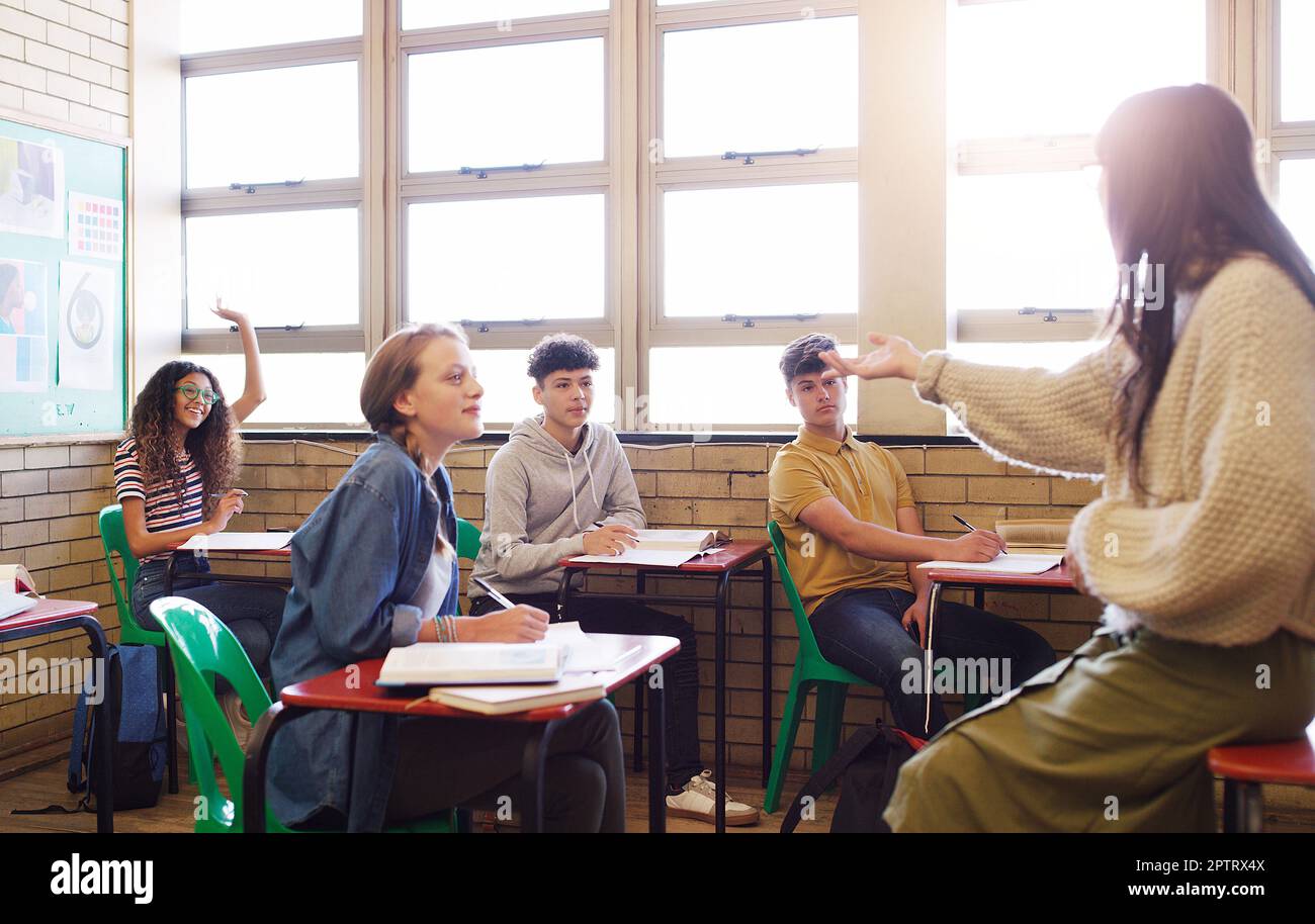 Yes feel free to ask. a cheerful young teacher giving class to a group ...