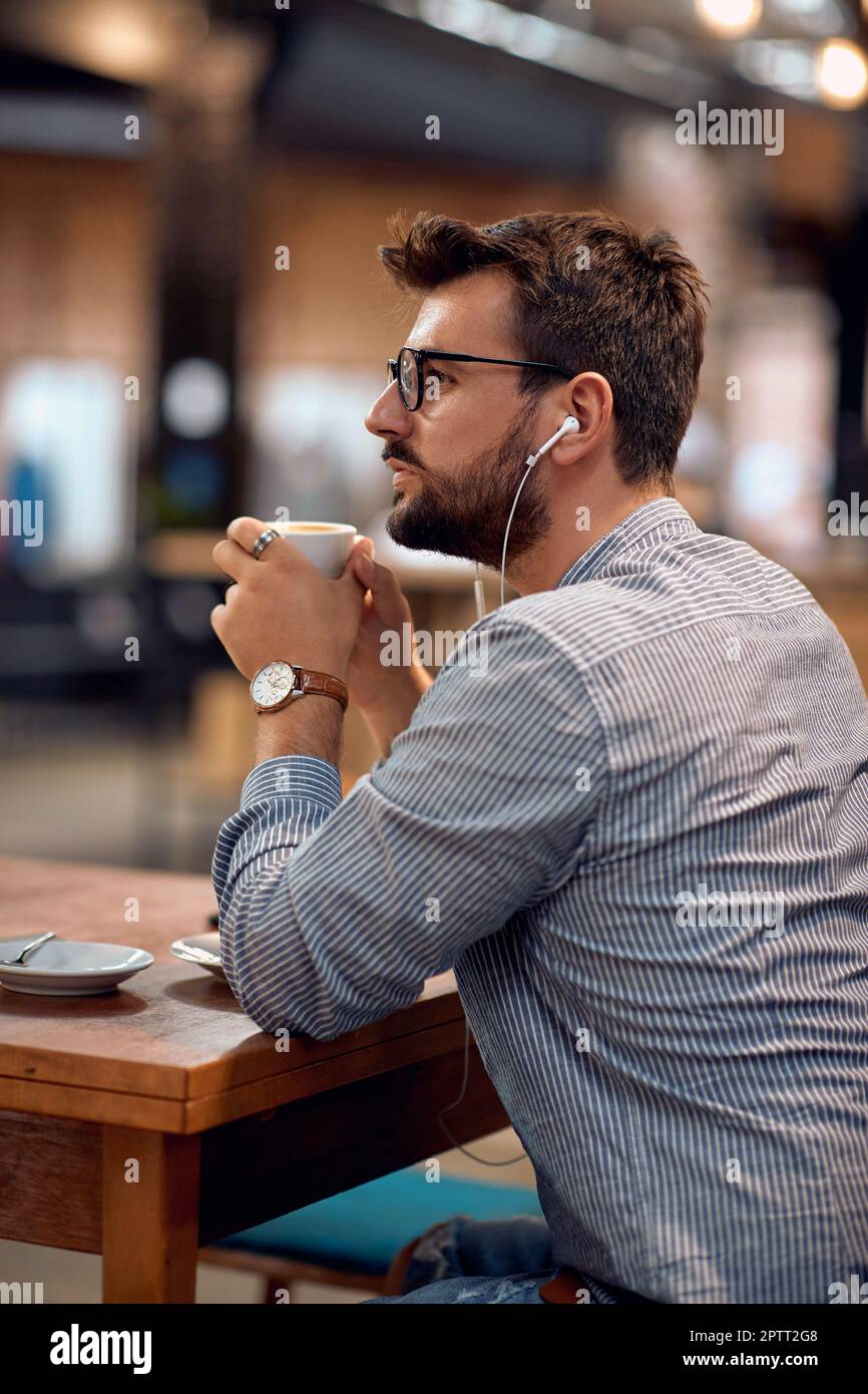 young business Man thinking, meditating, planing a future and drinking ...