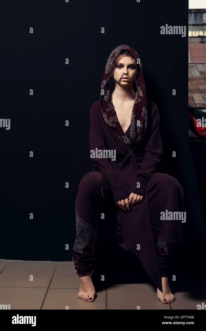 Low key portrait of a girl in bathrobe with hood Stock Photo - Alamy