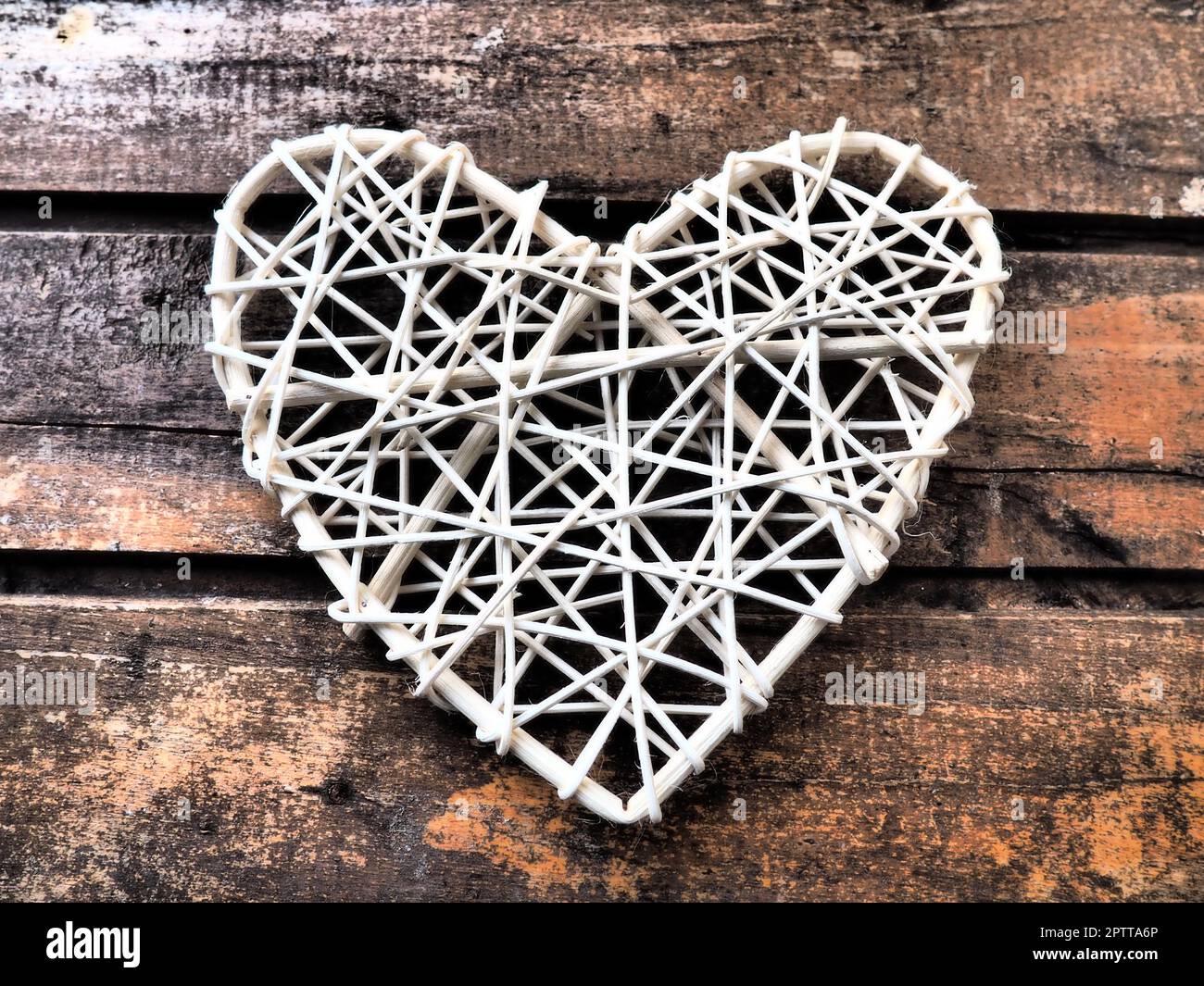 A heart woven from rustic light rods or threads. Wicker form handmade ...