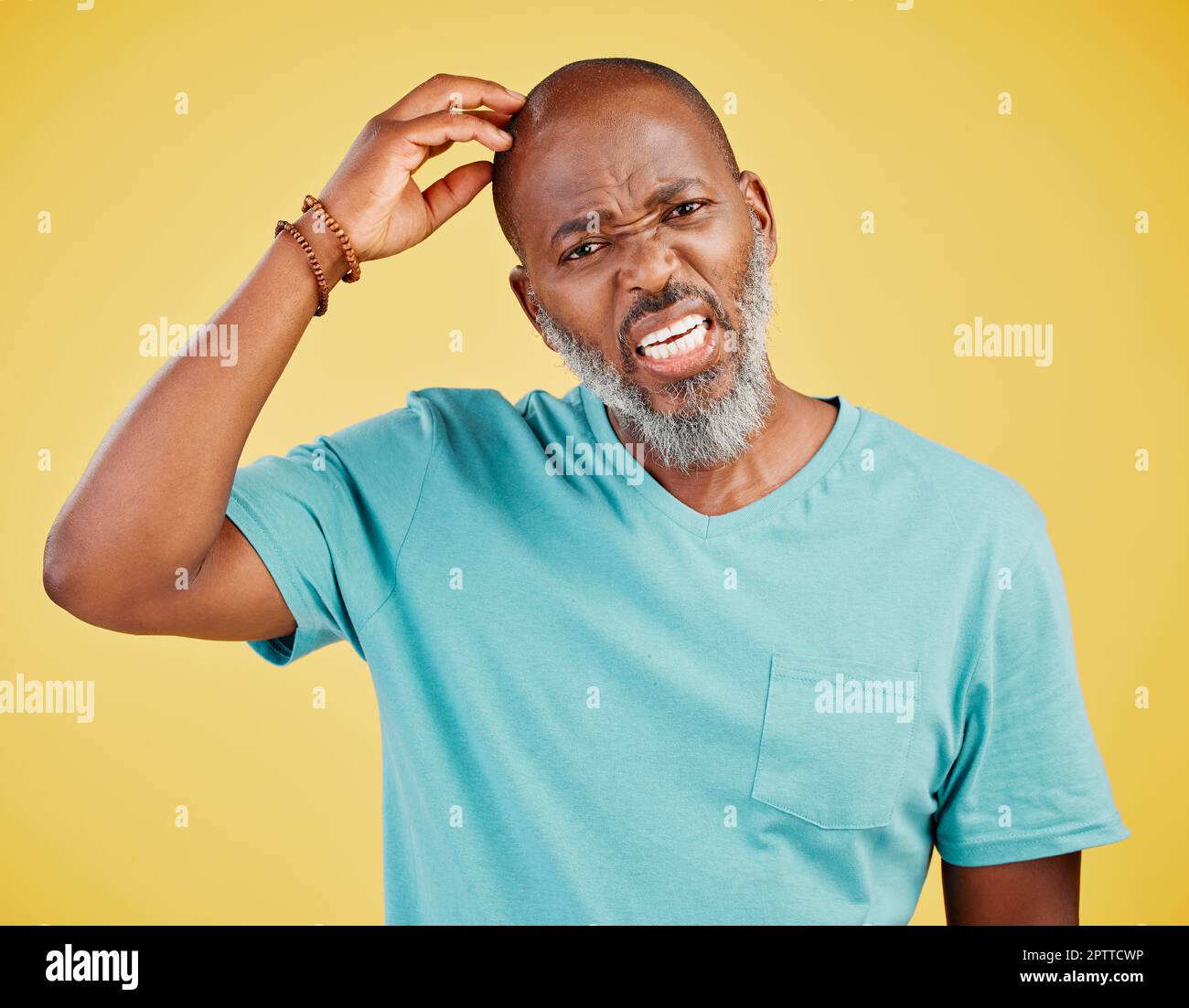 Mature african man thinking against a yellow studio background. Black ...