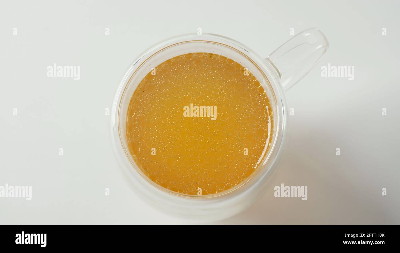 Chicken bone broth in transparent glass cup Stock Photo - Alamy