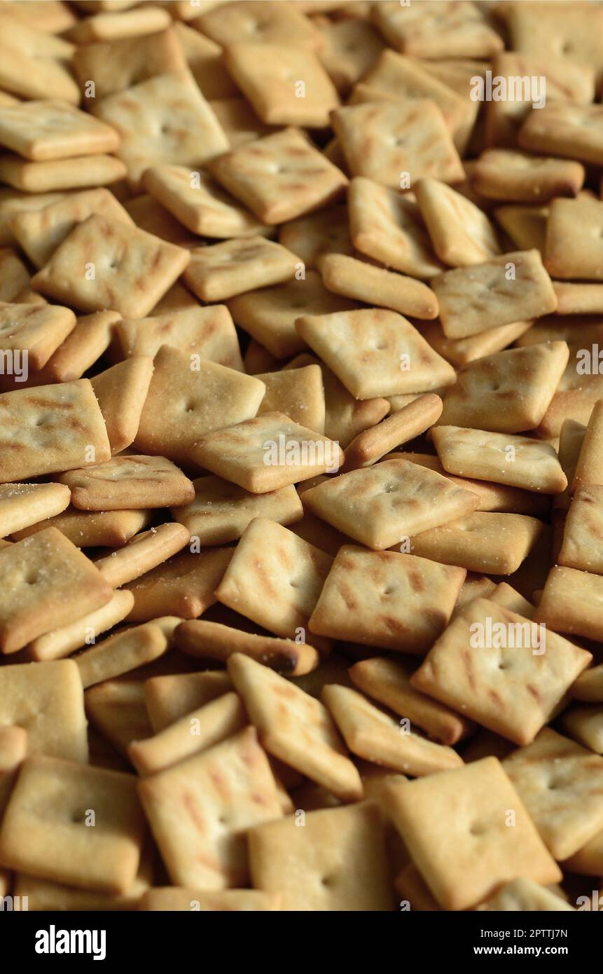 Background texture of small edible squares baked from dough and ...