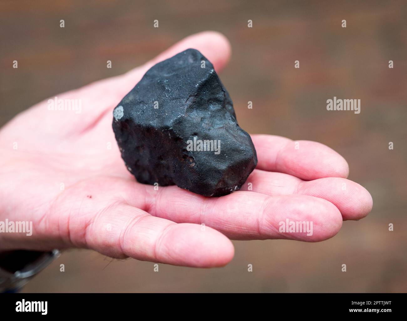 Elmshorn, Germany. 28th Apr, 2023. A homeowner holds a small meteorite ...