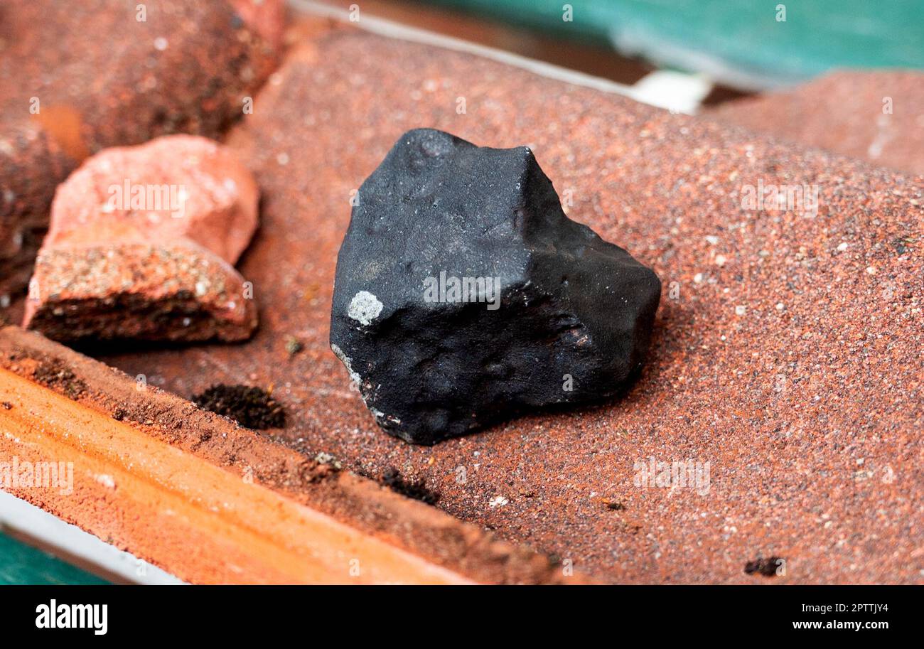 Elmshorn, Germany. 28th Apr, 2023. A small fallen meteorite lies on a ...