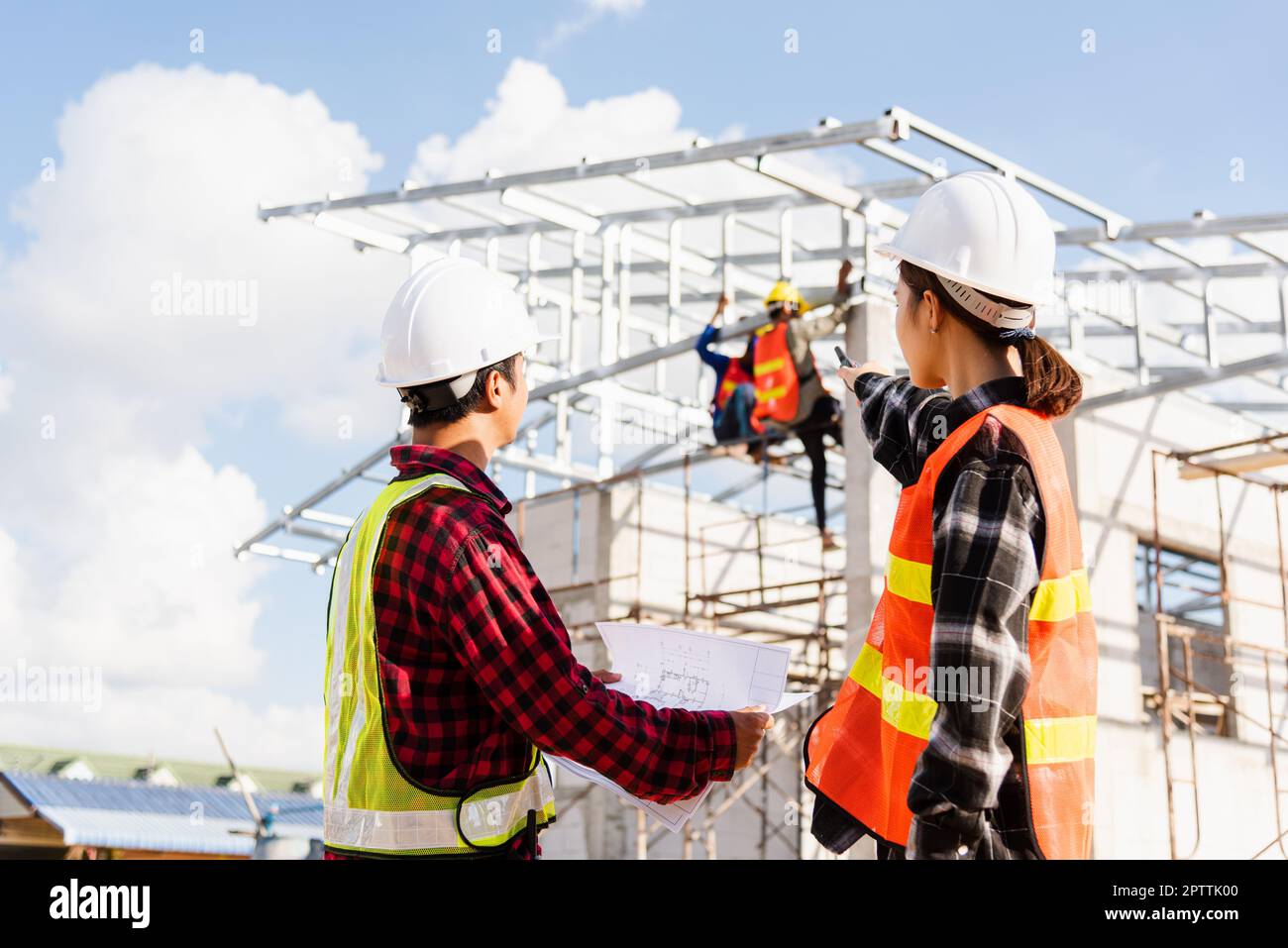 Back two architect and client discussing help create plan with ...