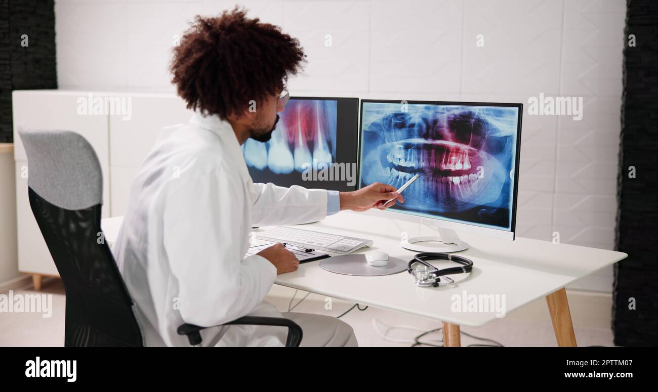 Dentist Looking At Teeth Xray Scan On Computer Stock Photo - Alamy