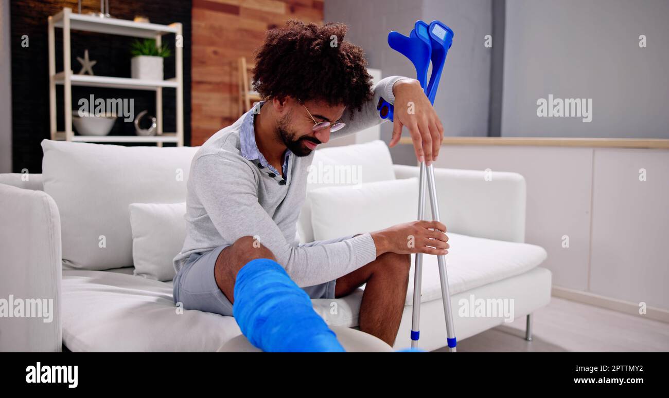Broken Leg In Cast Recovery. Man With Injury On Sofa Stock Photo - Alamy