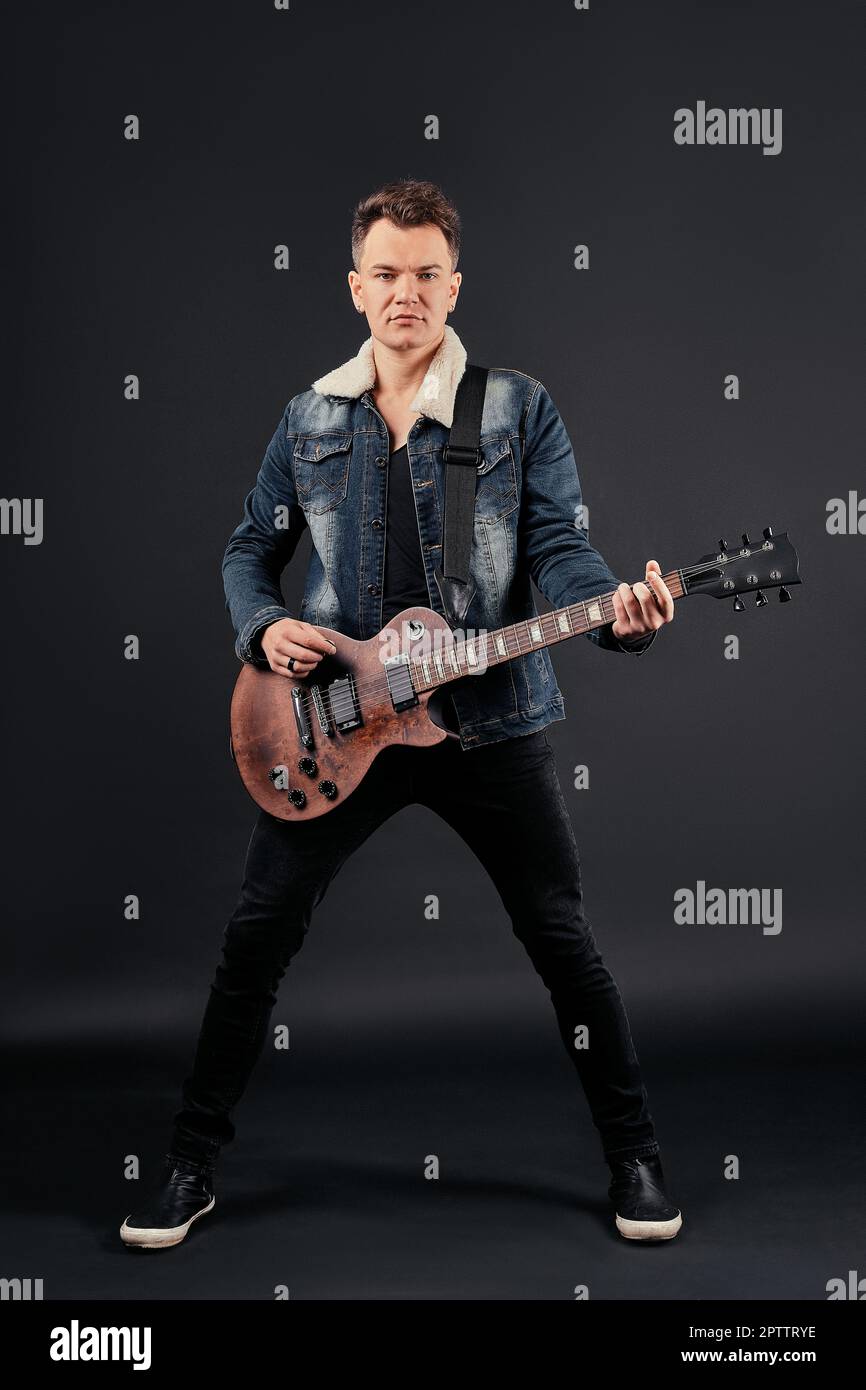 Full length portrait of artist playing guitar Stock Photo - Alamy