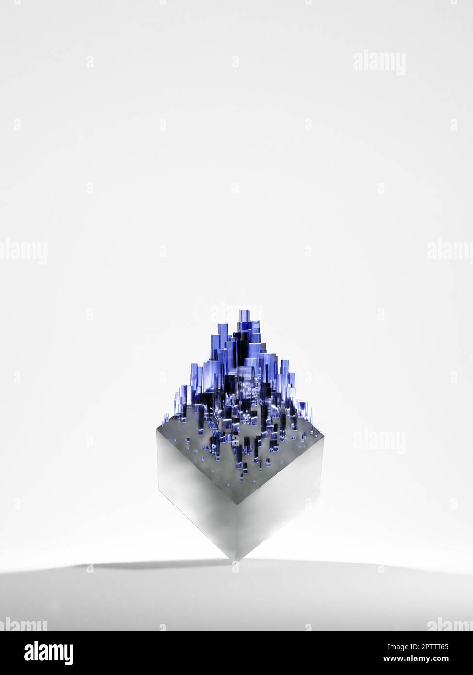 Blue, square crystal formation growing over a shiny, metallic cube ...
