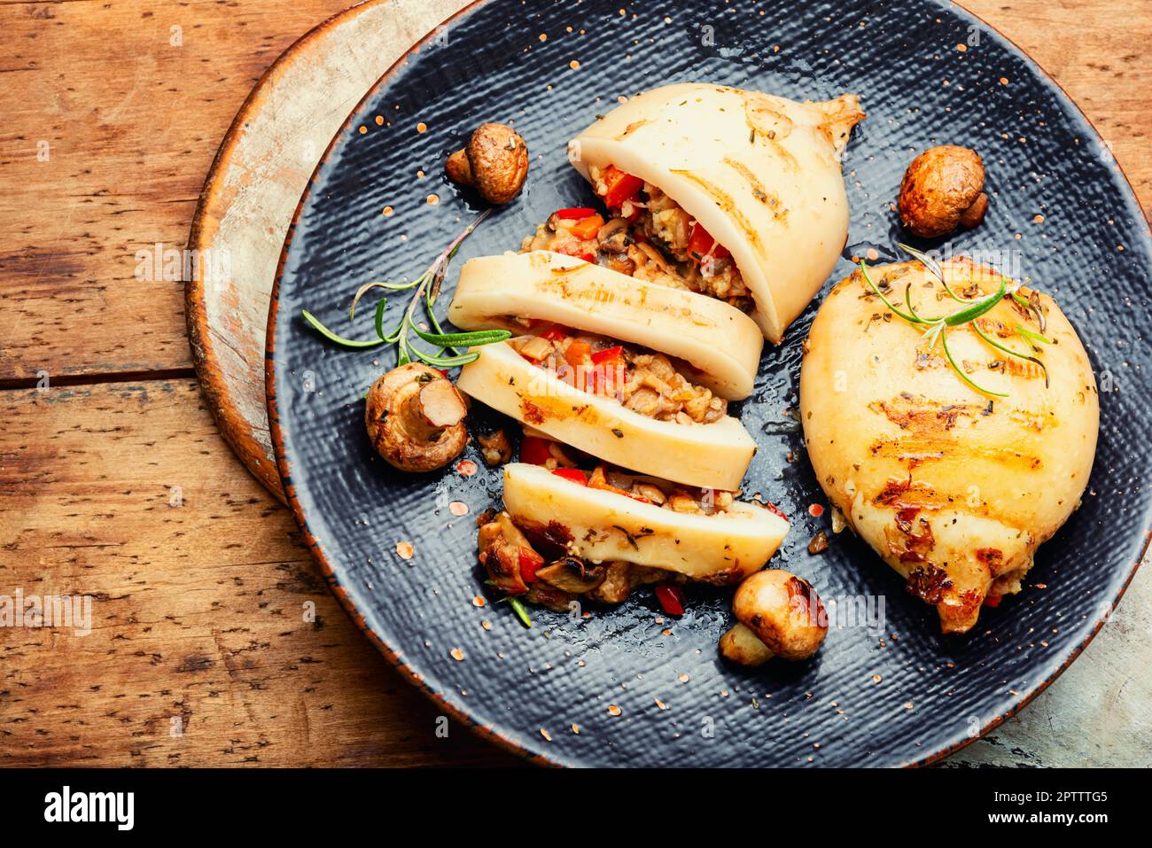 Tasty grilled squids with vegetable stuffing. Stuffed calamari. Seafood ...