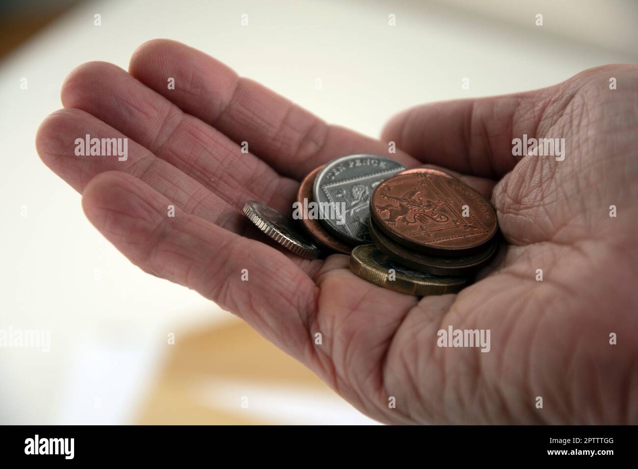 Collection of British coins in open hand Stock Photo - Alamy
