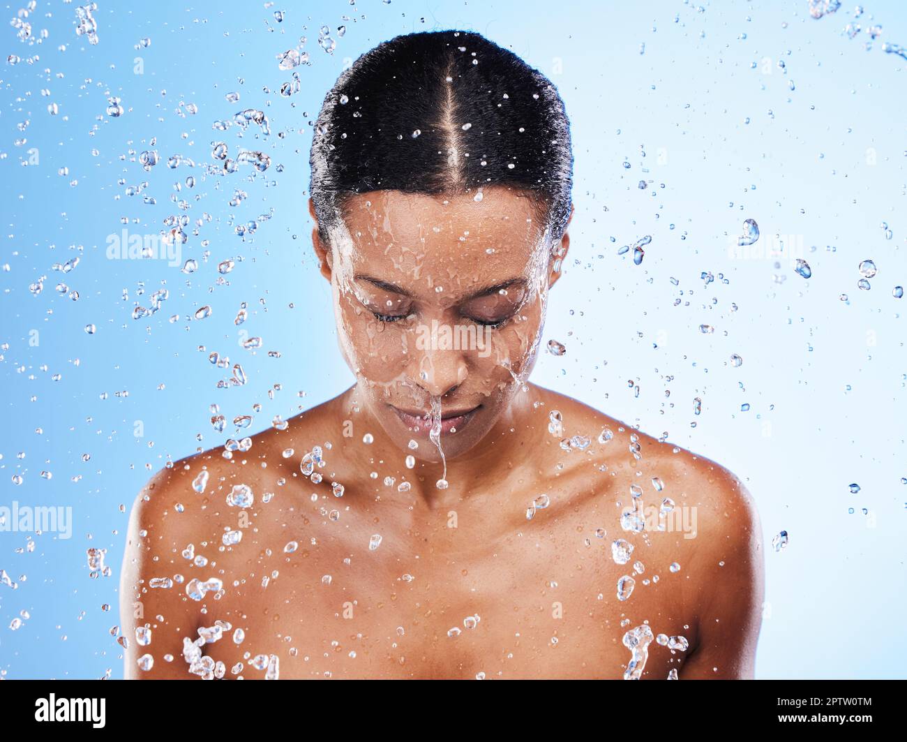 Woman, water or splash with skincare for beauty, moisturizer or self care by blue background ...
