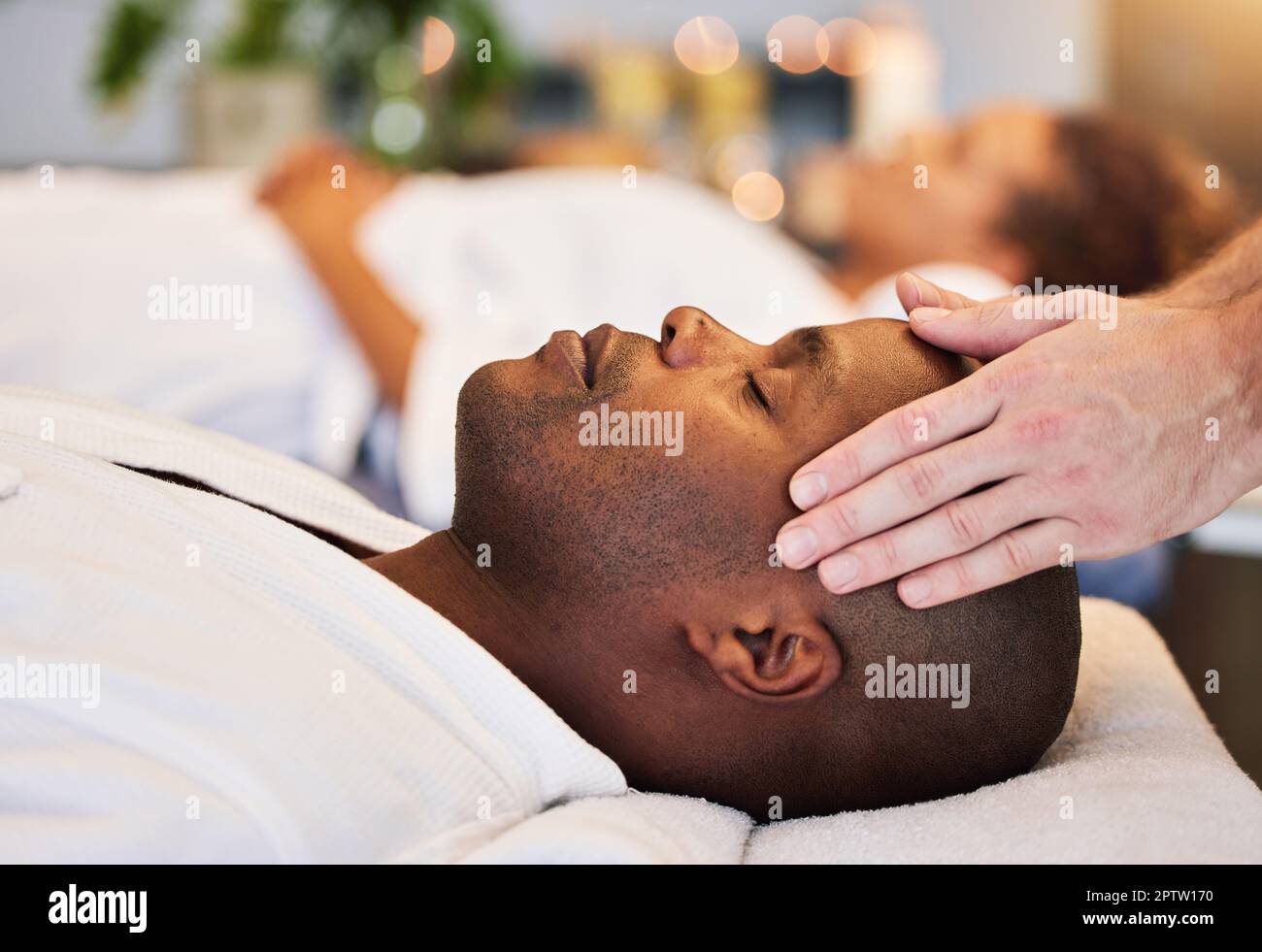 Black man, relax and head massage with therapist hands in a luxury spa ...
