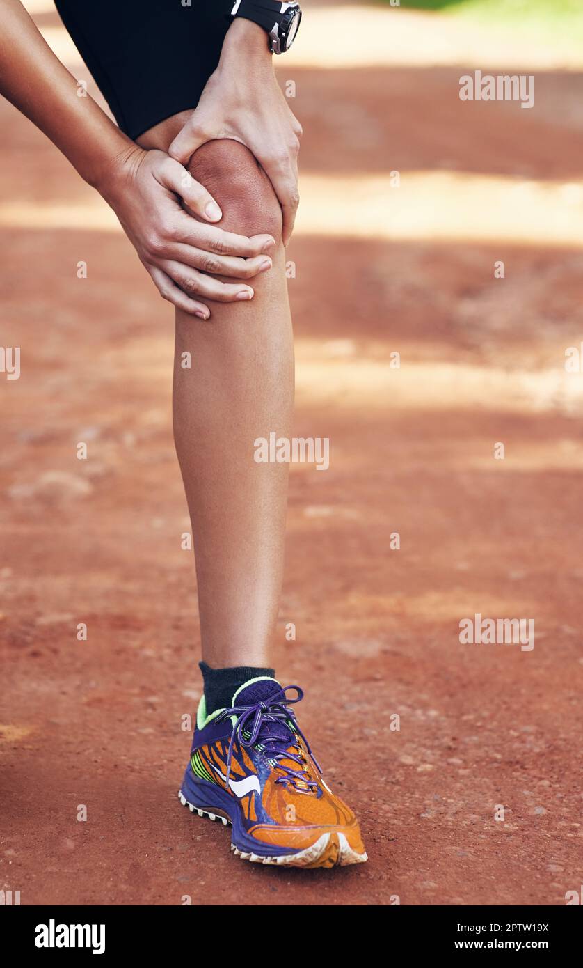 The inevitable runners knee. a runner holding onto her injured knee ...