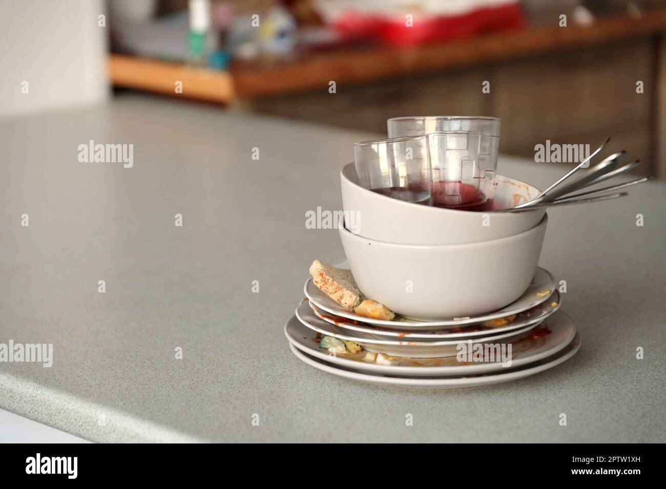 Stack of dirty dishes with food leftovers on the table after meal ...