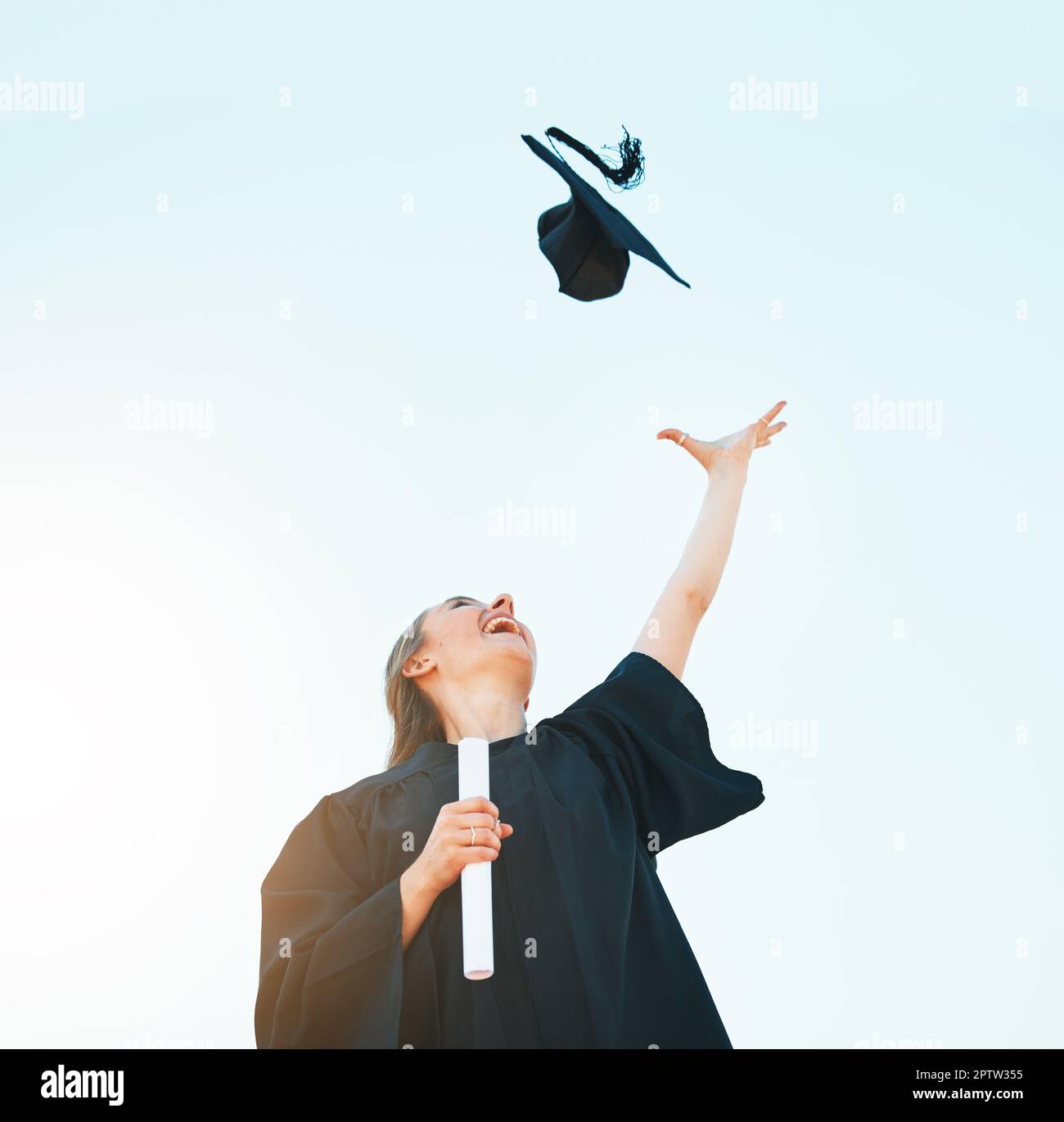 Woman celebrate graduation hat in blue sky for success, achievement and ...