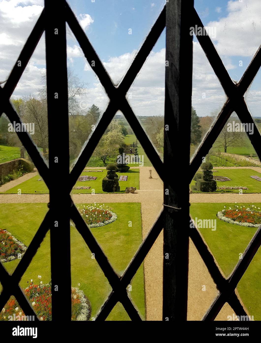 Detail of a lattice window with garden beyond Stock Photo - Alamy